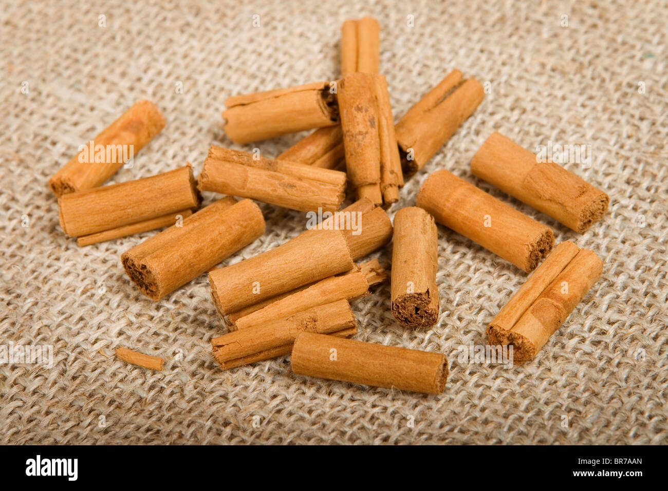 Cinnamon on canvas background Stock Photo - Alamy