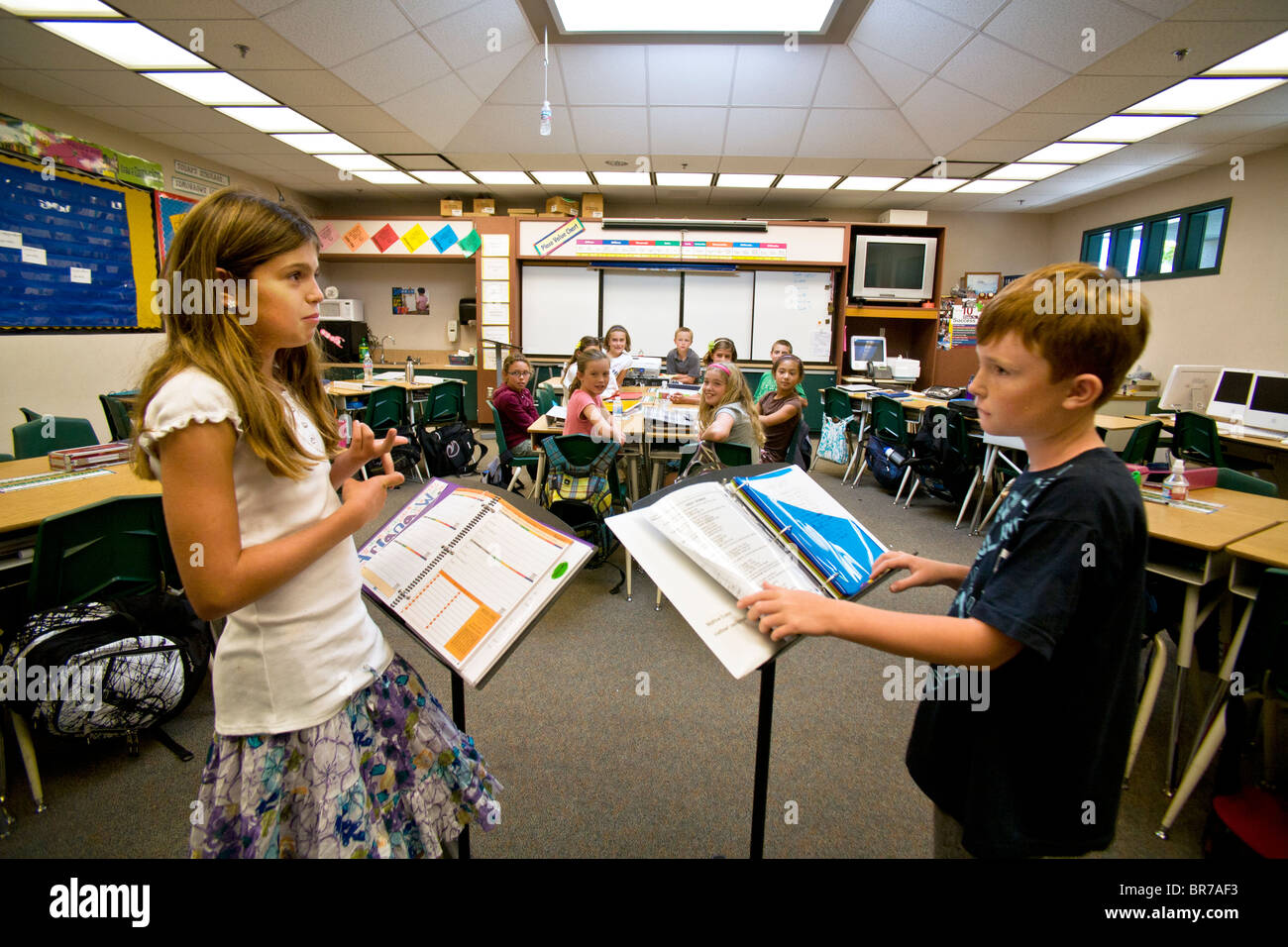 Working from notes, middle school students engage in a debate before ...