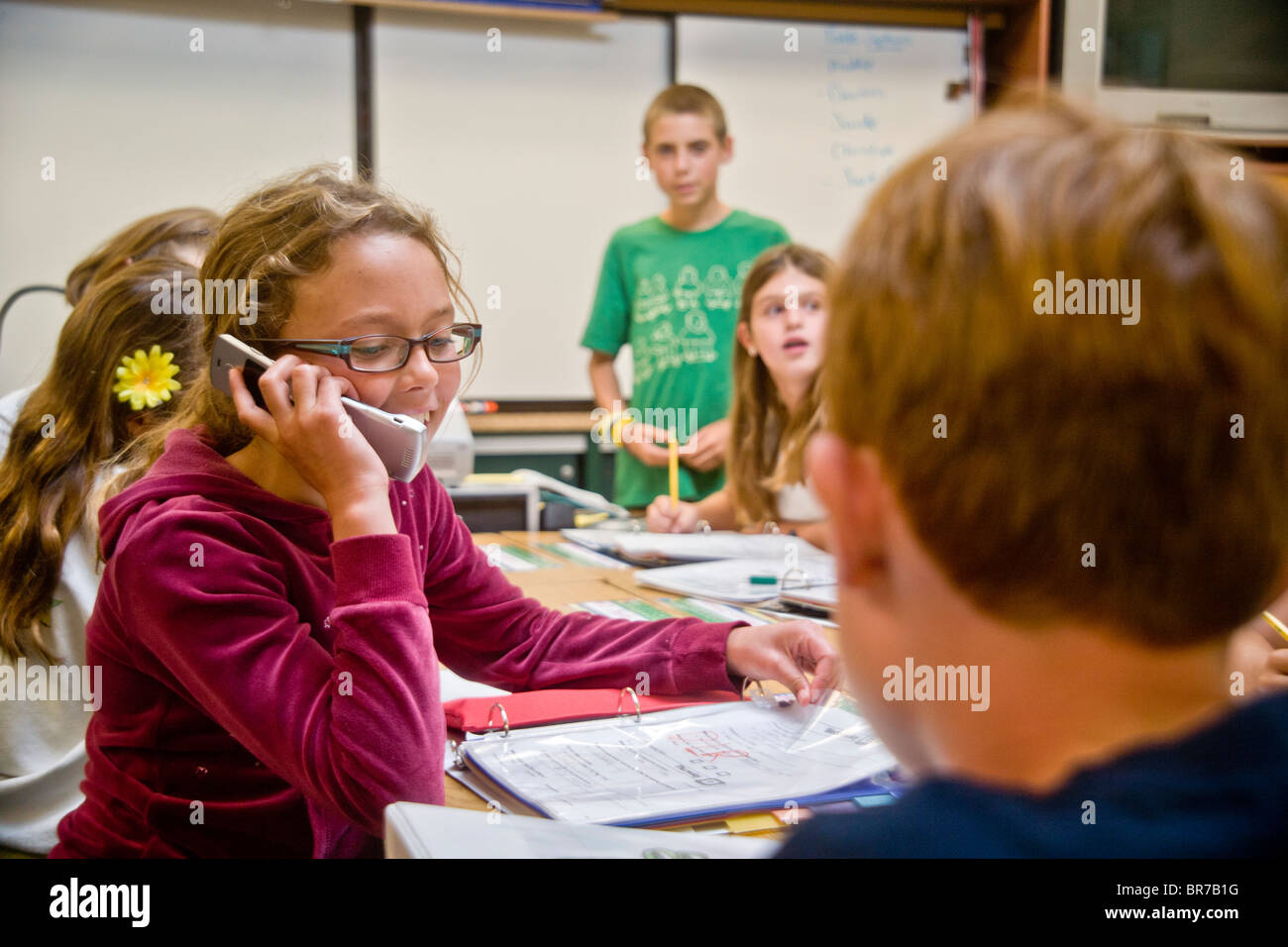 A middle school student uses a cell phone in class in San Clemente, CA ...