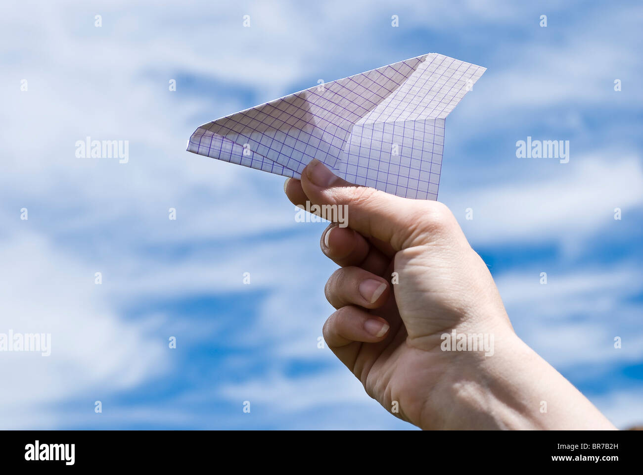 Hand holding a paper airplane on sky background Stock Photo - Alamy