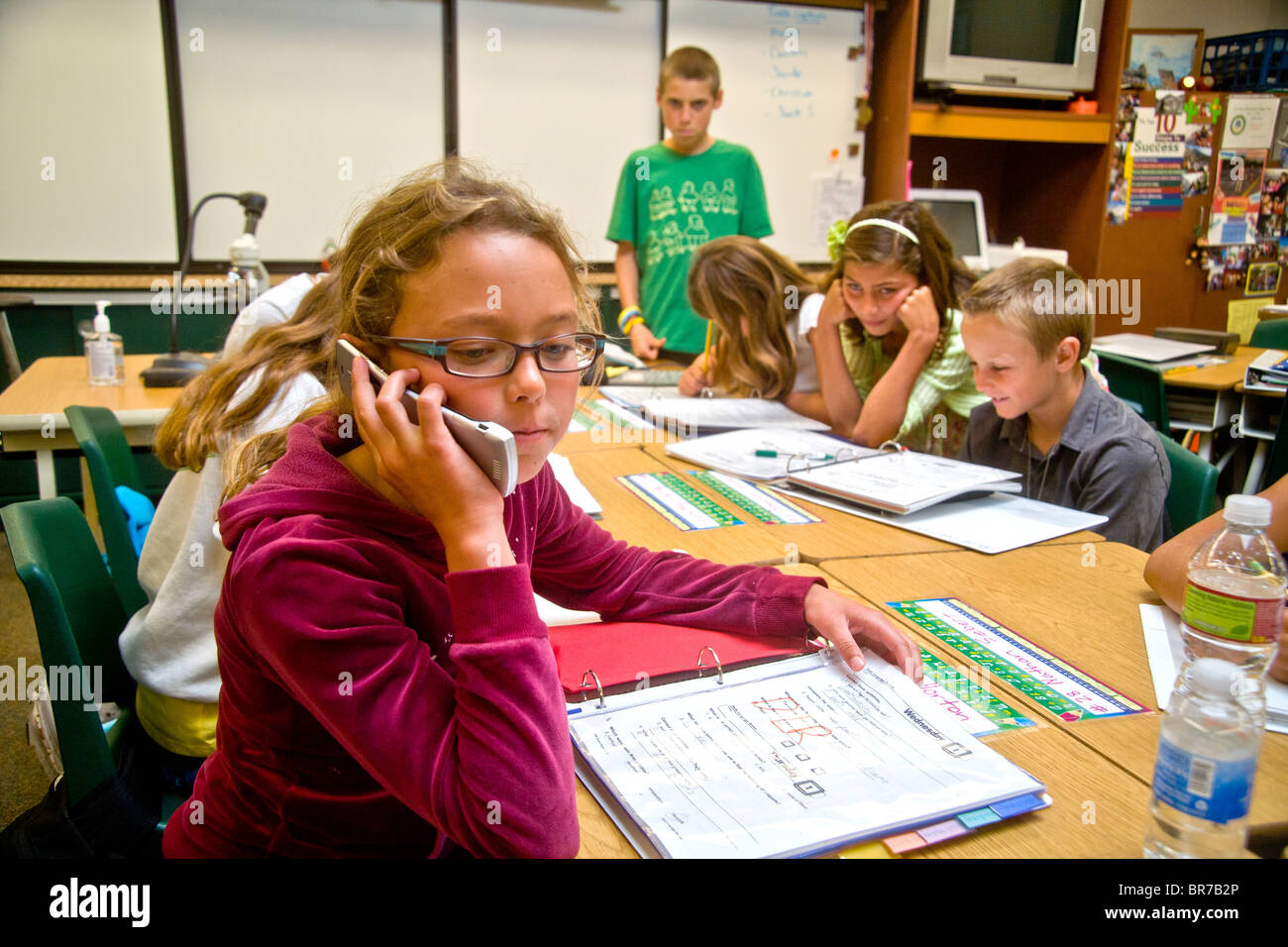 A middle school student uses a cell phone in class in San Clemente, CA ...