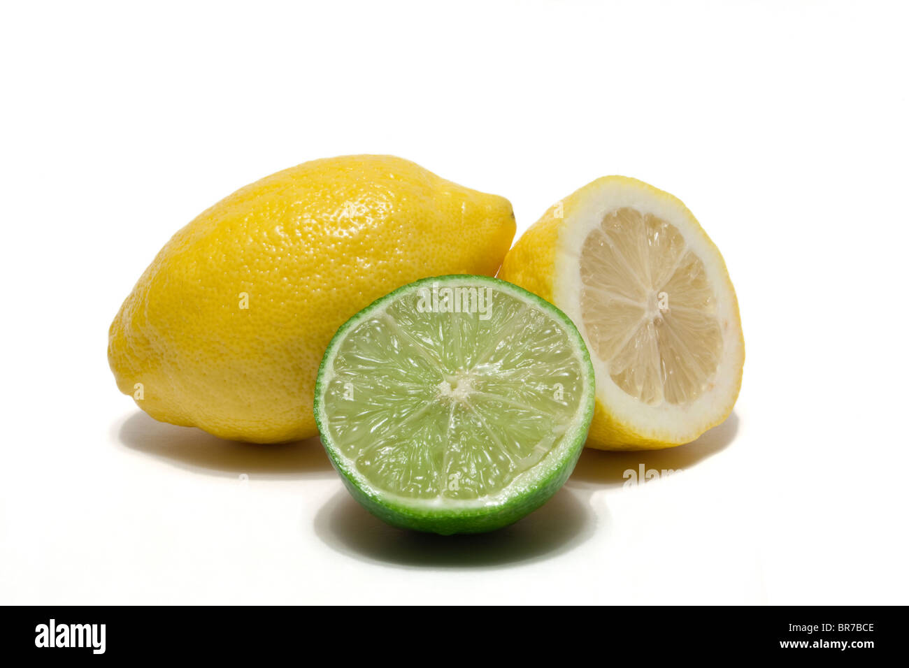 Lemons and a sliced lime half Stock Photo - Alamy