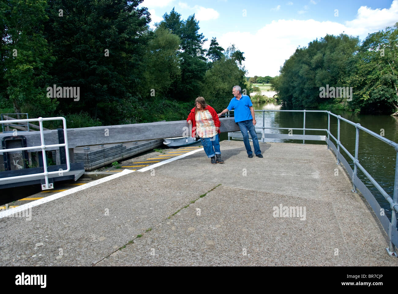 Man and women opening a lock gate Stock Photo - Alamy