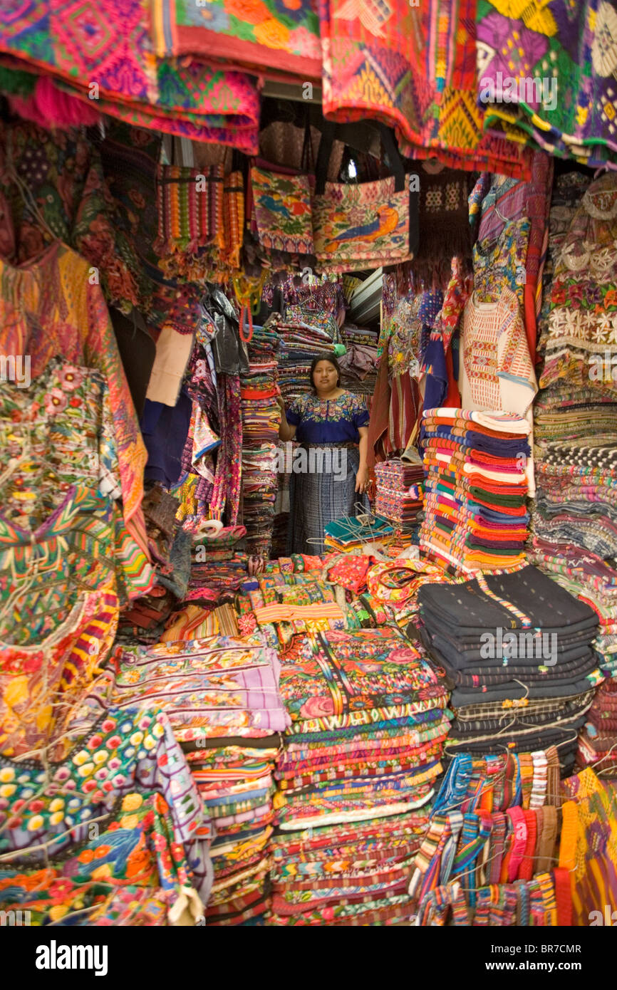A local vendor sells her wares of authentic and colorful textiles in ...