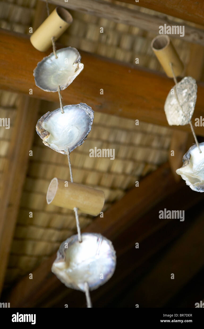 seashell mobile hanging from a woven hut ceiling Stock Photo - Alamy