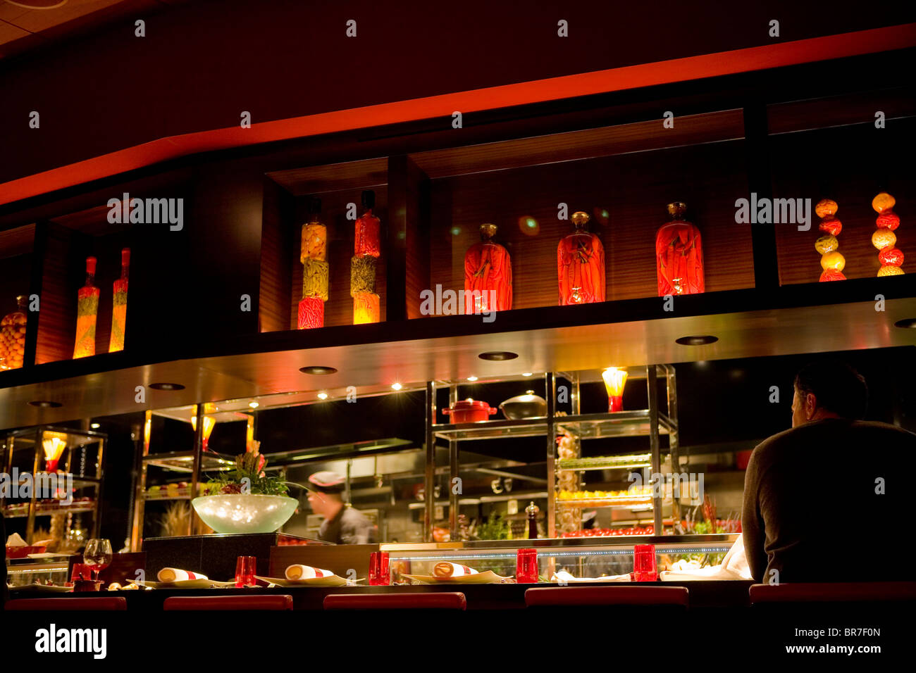 A man sits at a restaurant counter Stock Photo - Alamy