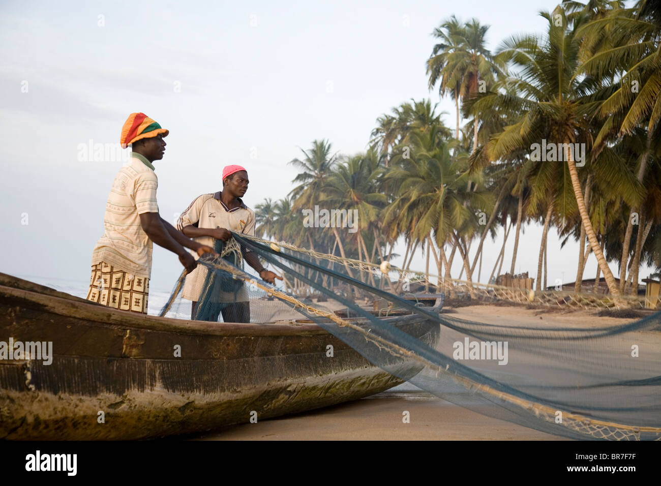 Fishermen pulling nets on a beach in Ghana Stock Photo - Alamy