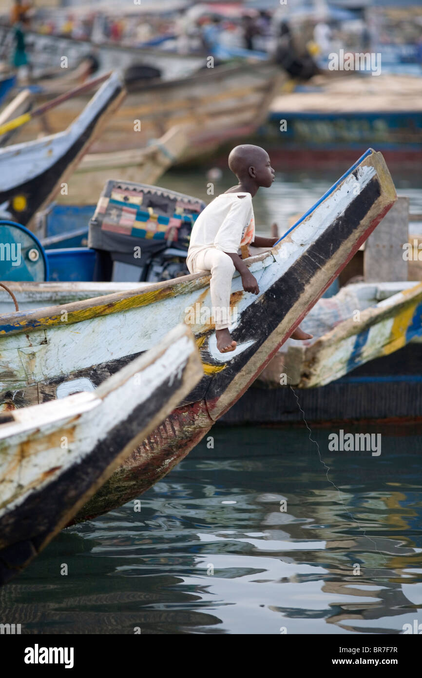 Young boy fishing in Elmina Harbour Stock Photo - Alamy