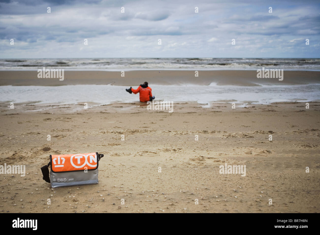 post man sitting along the shore Stock Photo - Alamy