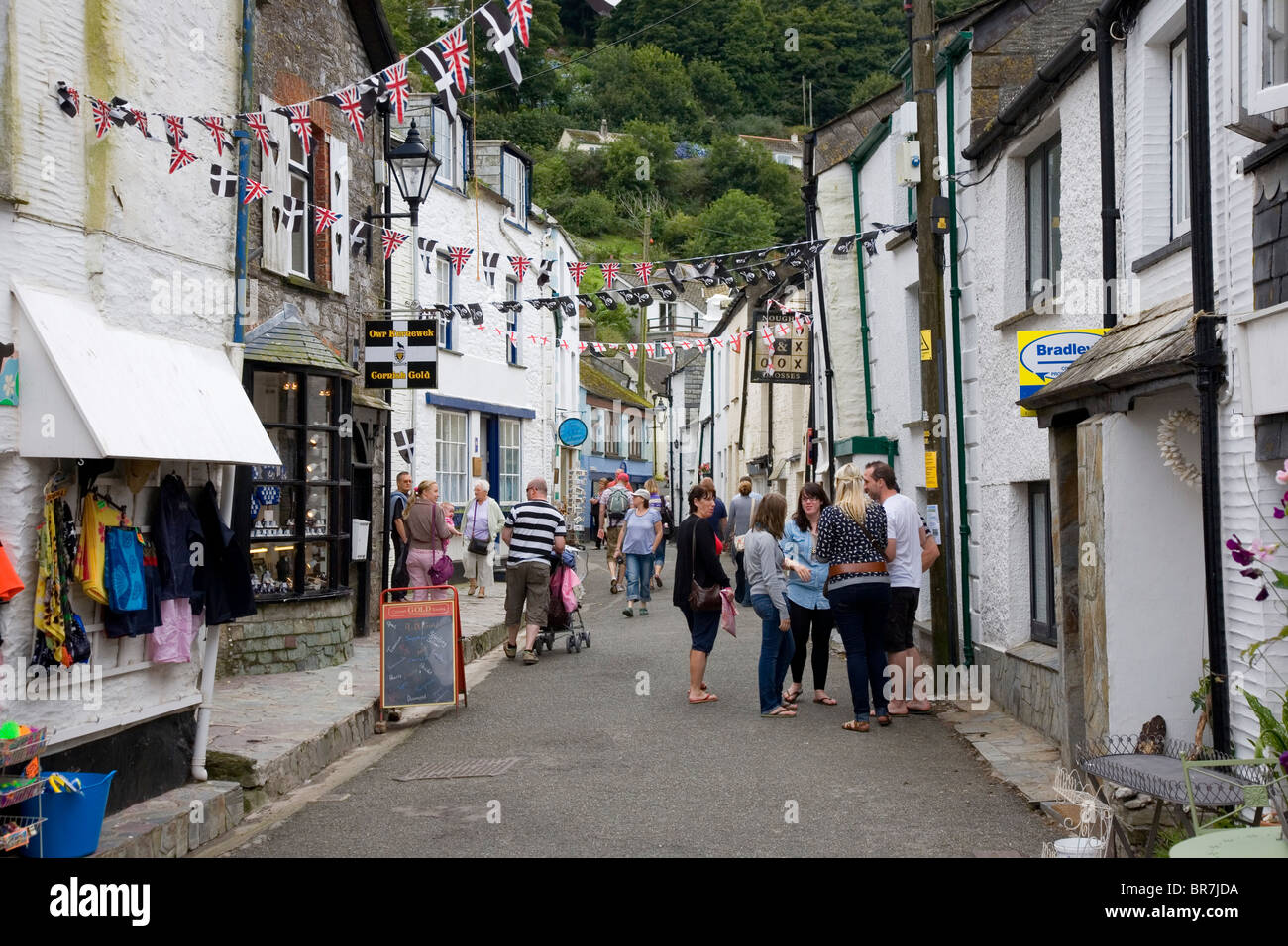 Tourists walking shopping the narrow streets of the traditional fishing ...