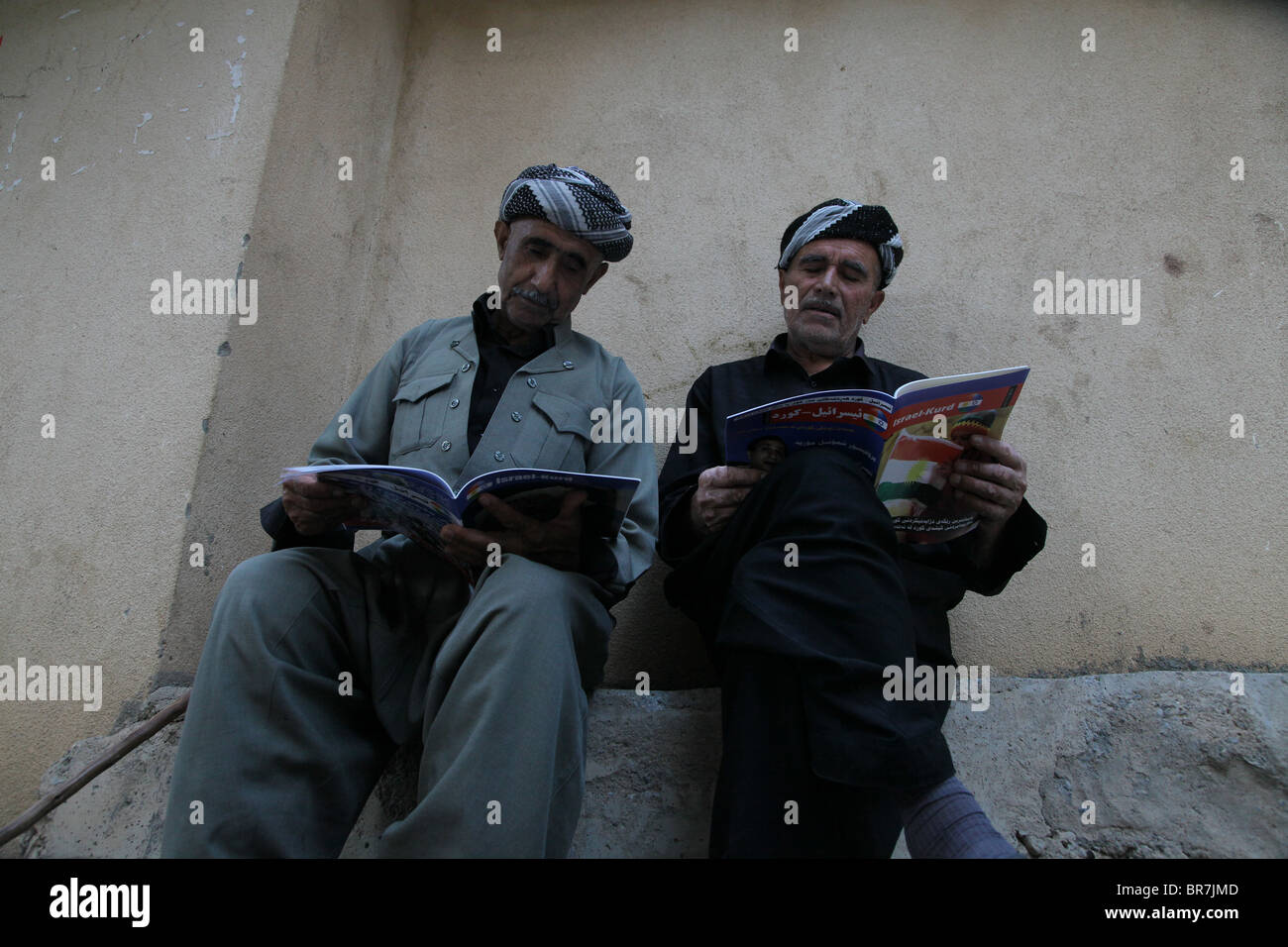 Kurdish men wearing traditional garment reading magazines in Northern ...