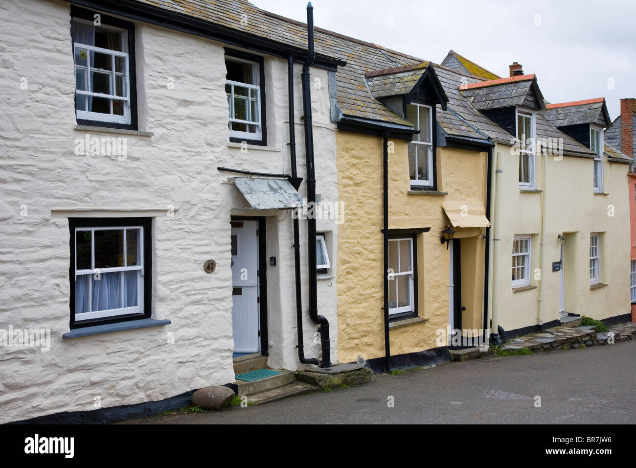 Row of traditional painted whitewashed stone fishermans cottages at ...