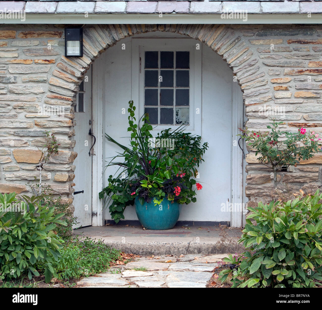 An old stone cottage with a garden. Late summer in the garden Stock ...