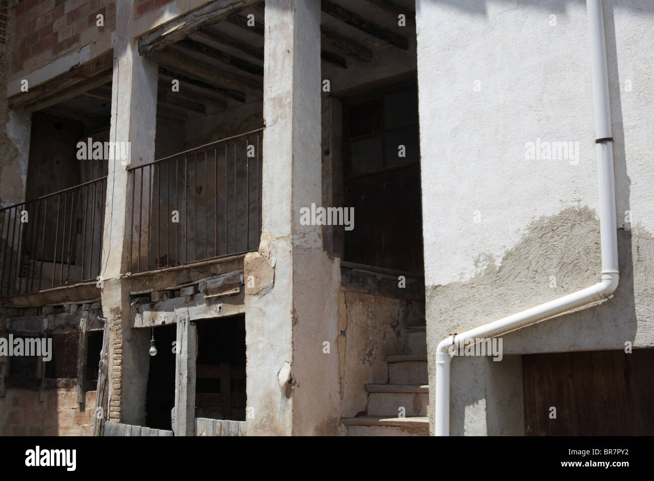 The back of run-down concrete rendered house in Olot Catalonia Spain ...