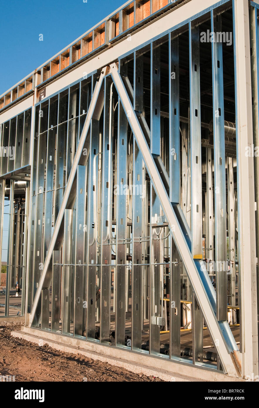 A framework of structural steel is constructed to support a wall in a ...
