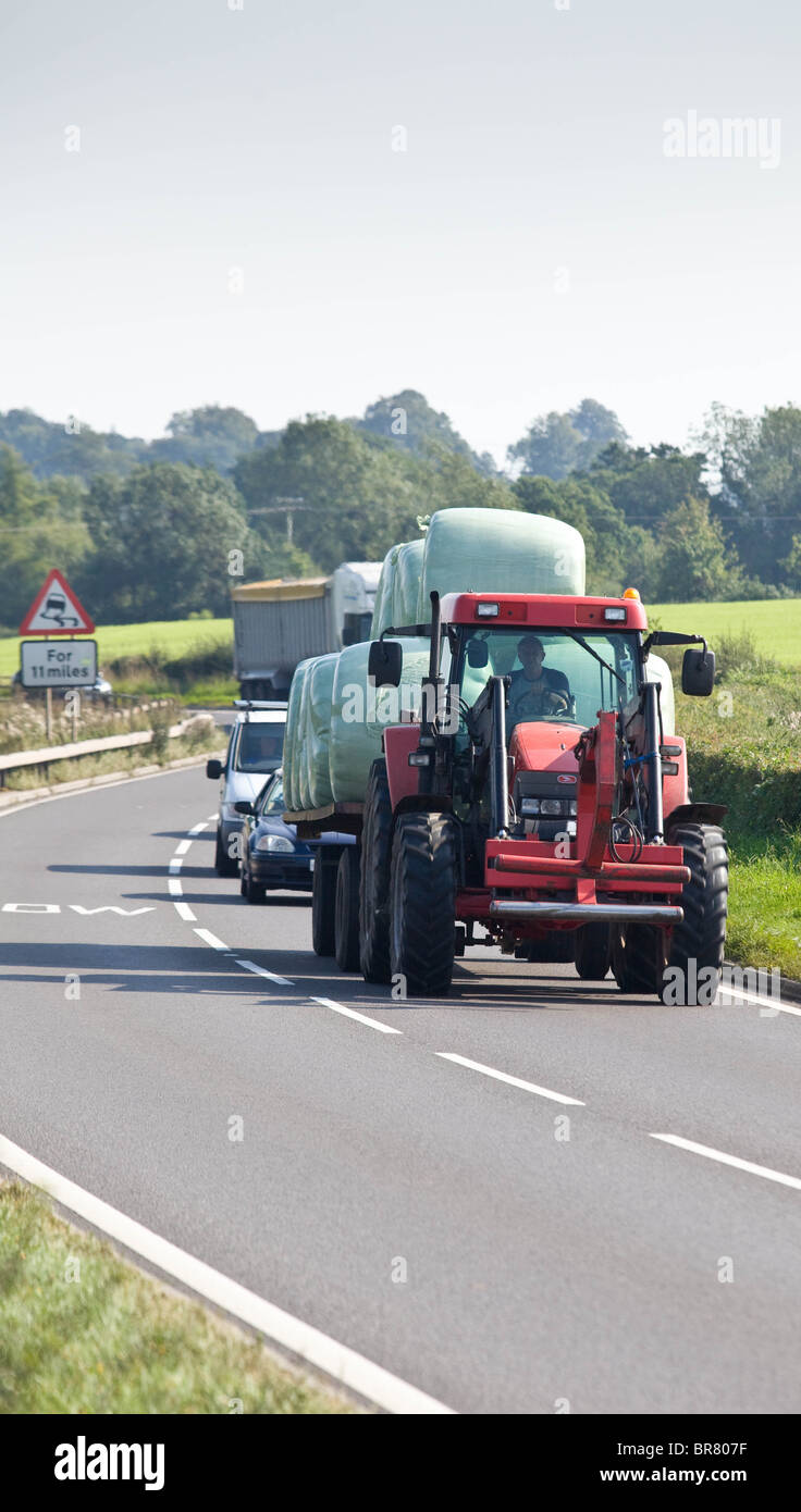 Farm tractor with traffic behind it on a rural road Stock Photo - Alamy