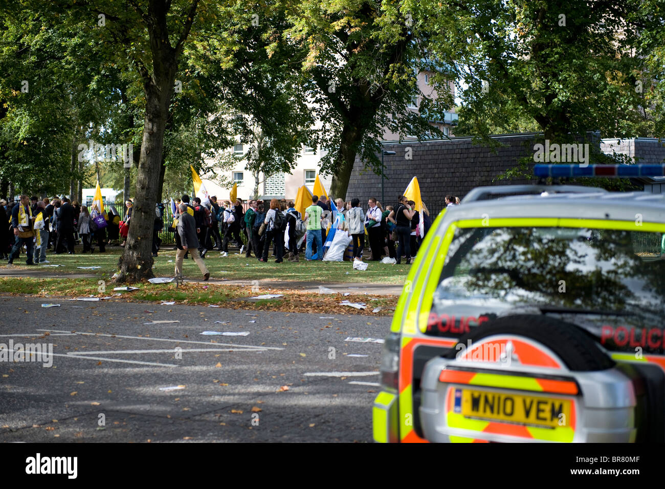 A police car in the foreground of a crowd of people attending the Papal ...