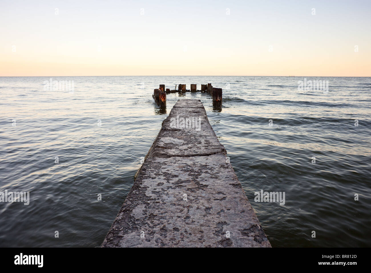 old pier at the sea at sunset Stock Photo - Alamy