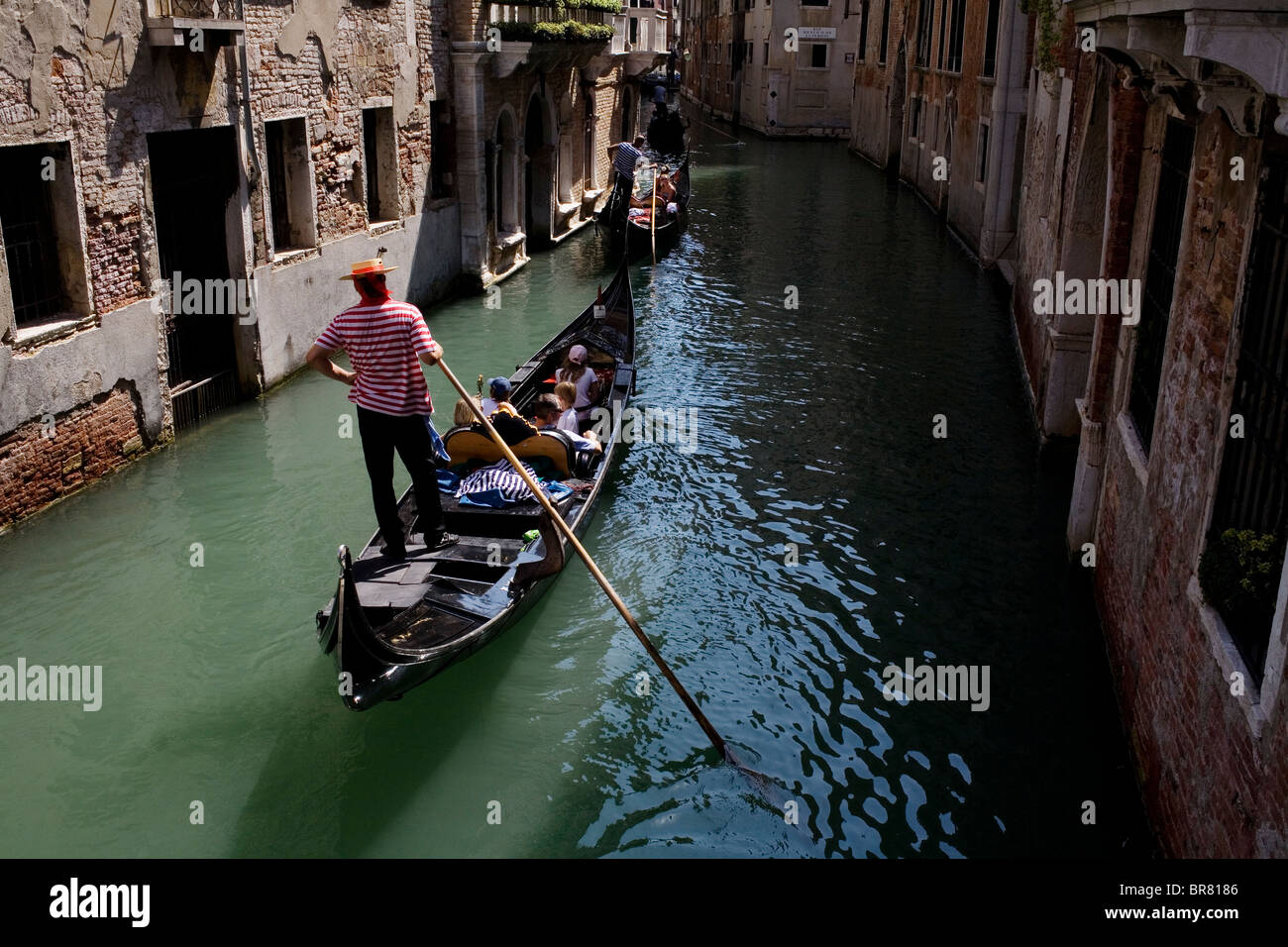 Venetian gondolas sailing along a canal in Venice Stock Photo - Alamy
