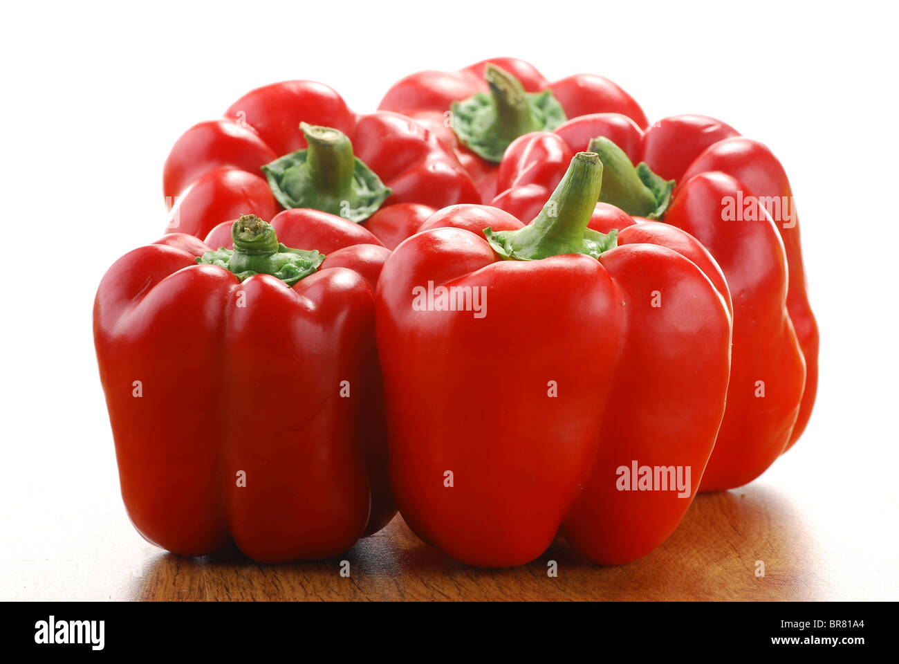 Red peppers on kitchen table Stock Photo - Alamy