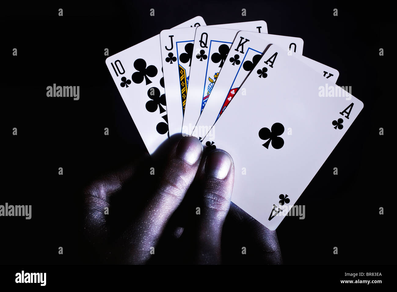 Playing cards in the silver hands Stock Photo - Alamy