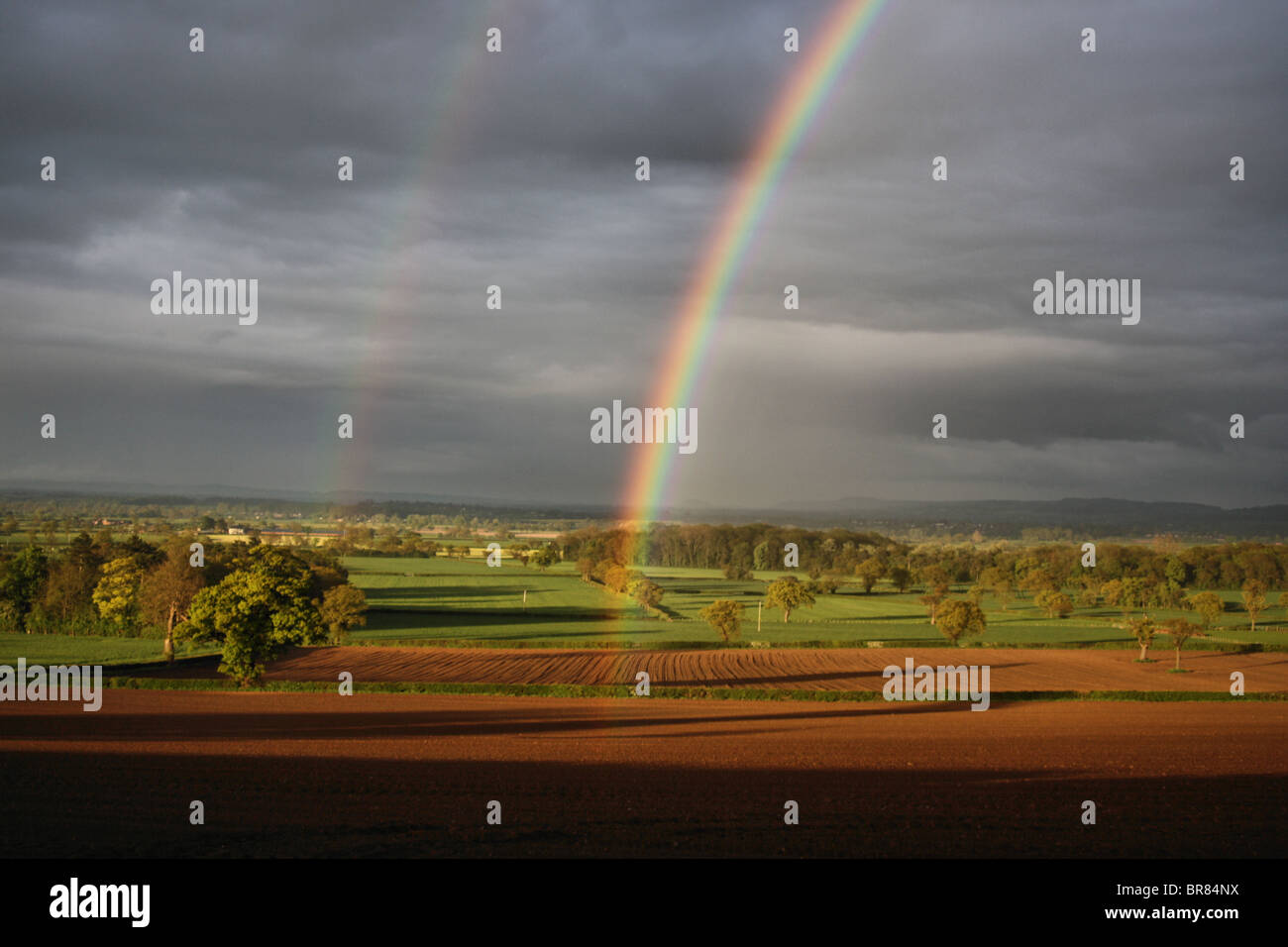 Dual rainbow over farmland with views to Beeston castle and headland ...