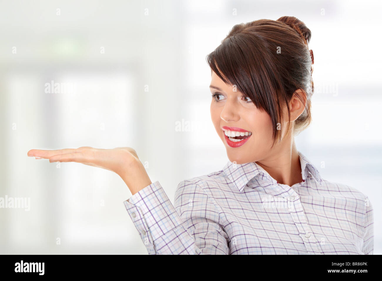 Young happy businesswoman presenting something on her hand Stock Photo ...