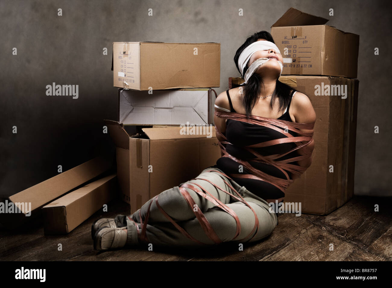 A Young Woman Tied Up Blind Folded And Muted In Old Room Low Key