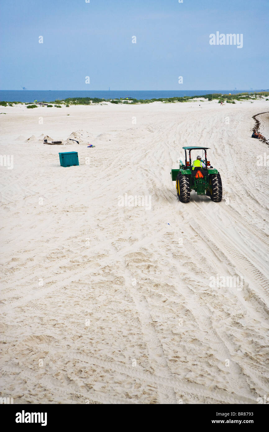Oil spill clean-up crews work on white beaches along the Gulf Coast ...