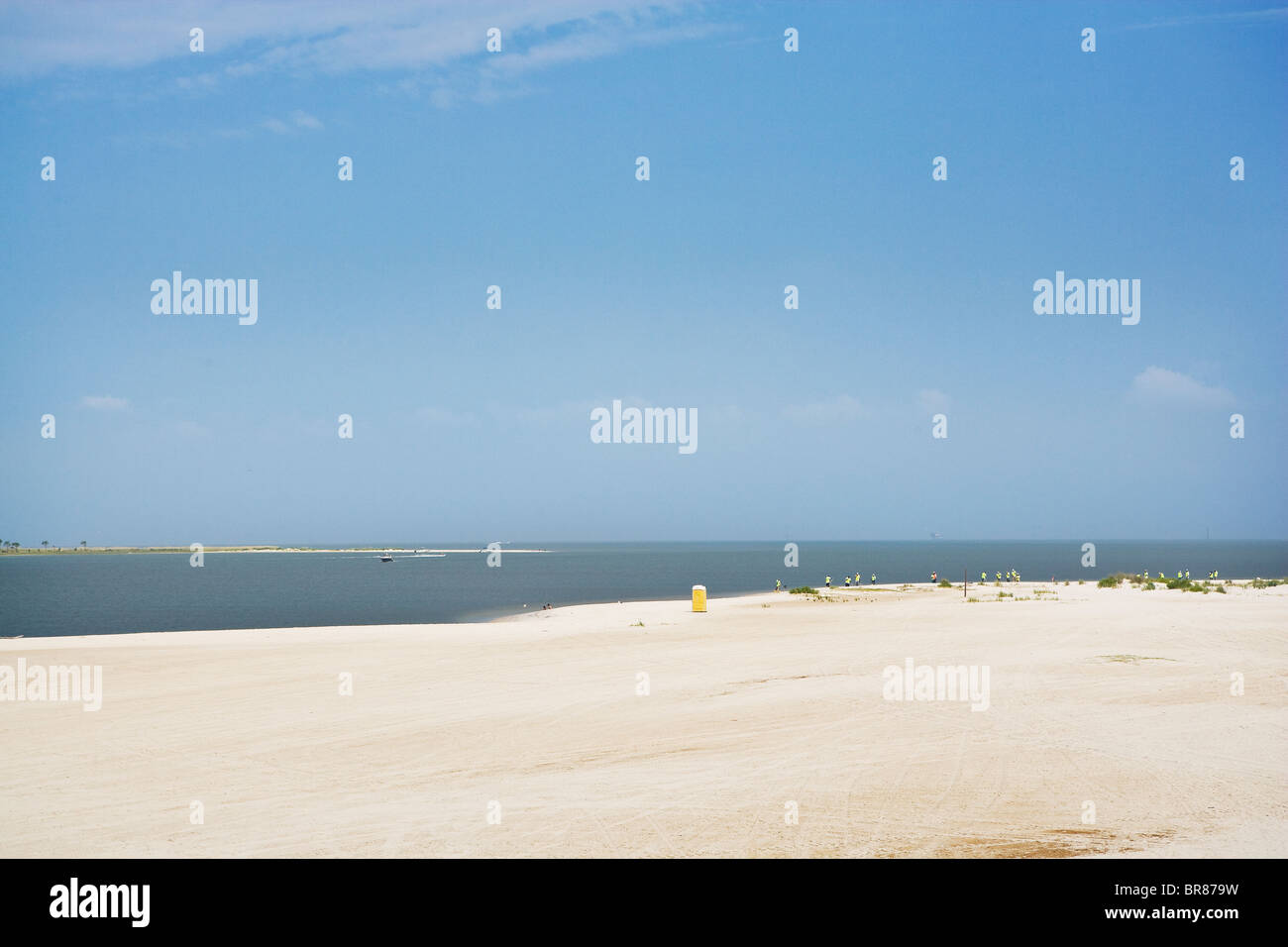 Oil spill clean-up crews work on white beaches along the Gulf Coast ...
