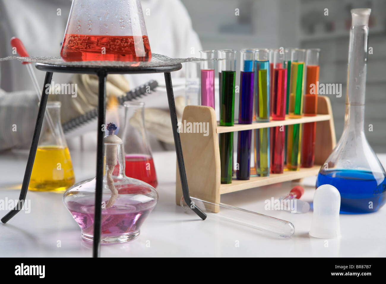 Scientist doing experiment in laboratory with lot of equipment and ...