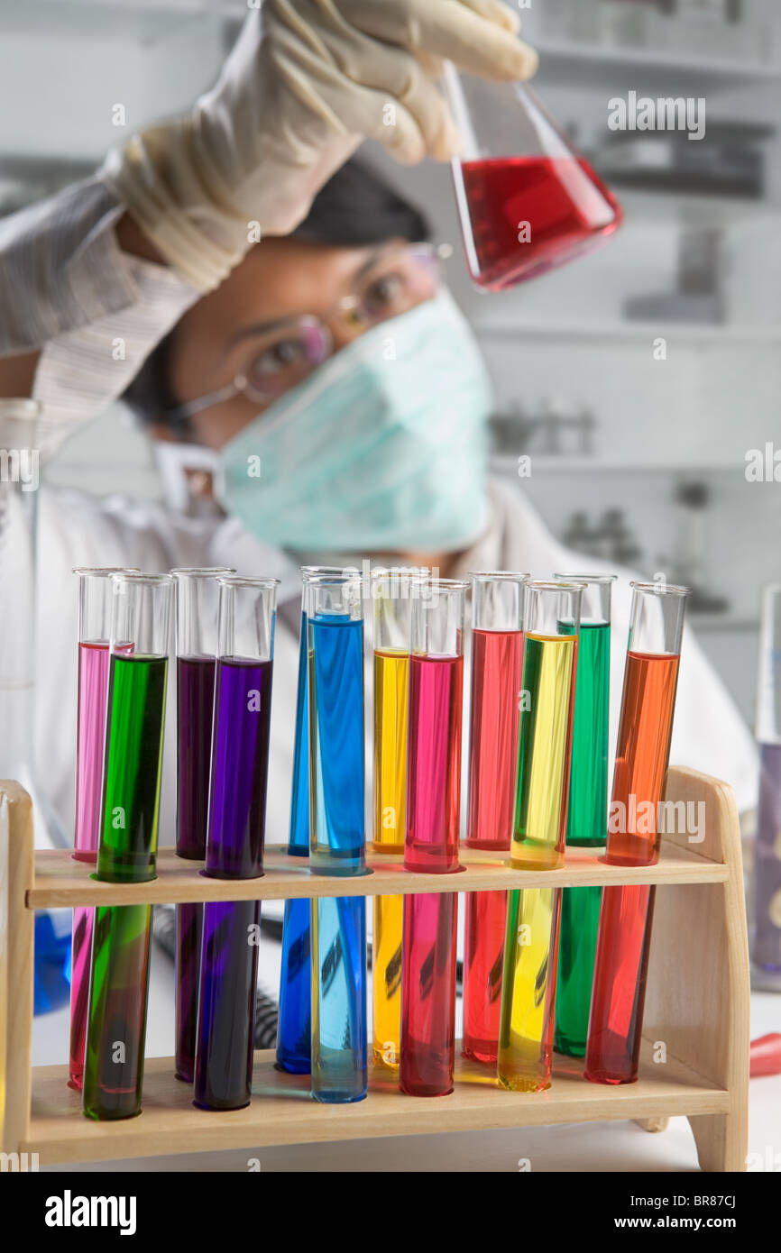 Scientist examining chemical solution in laboratory. Focus on test tube ...