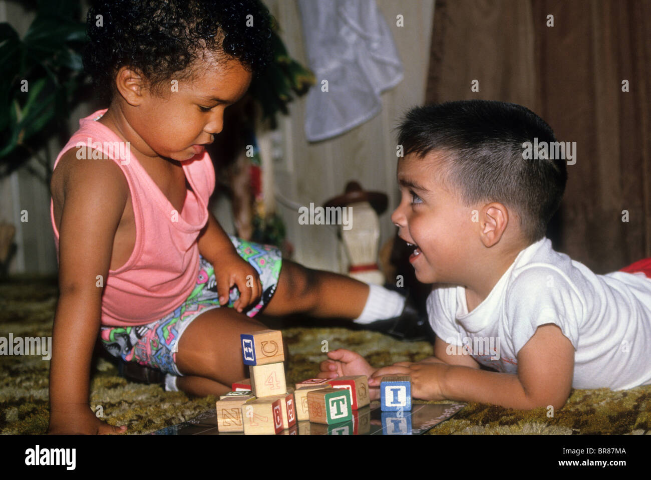 Hispanic boy black toddler play with blocks on floor fun learn share ...