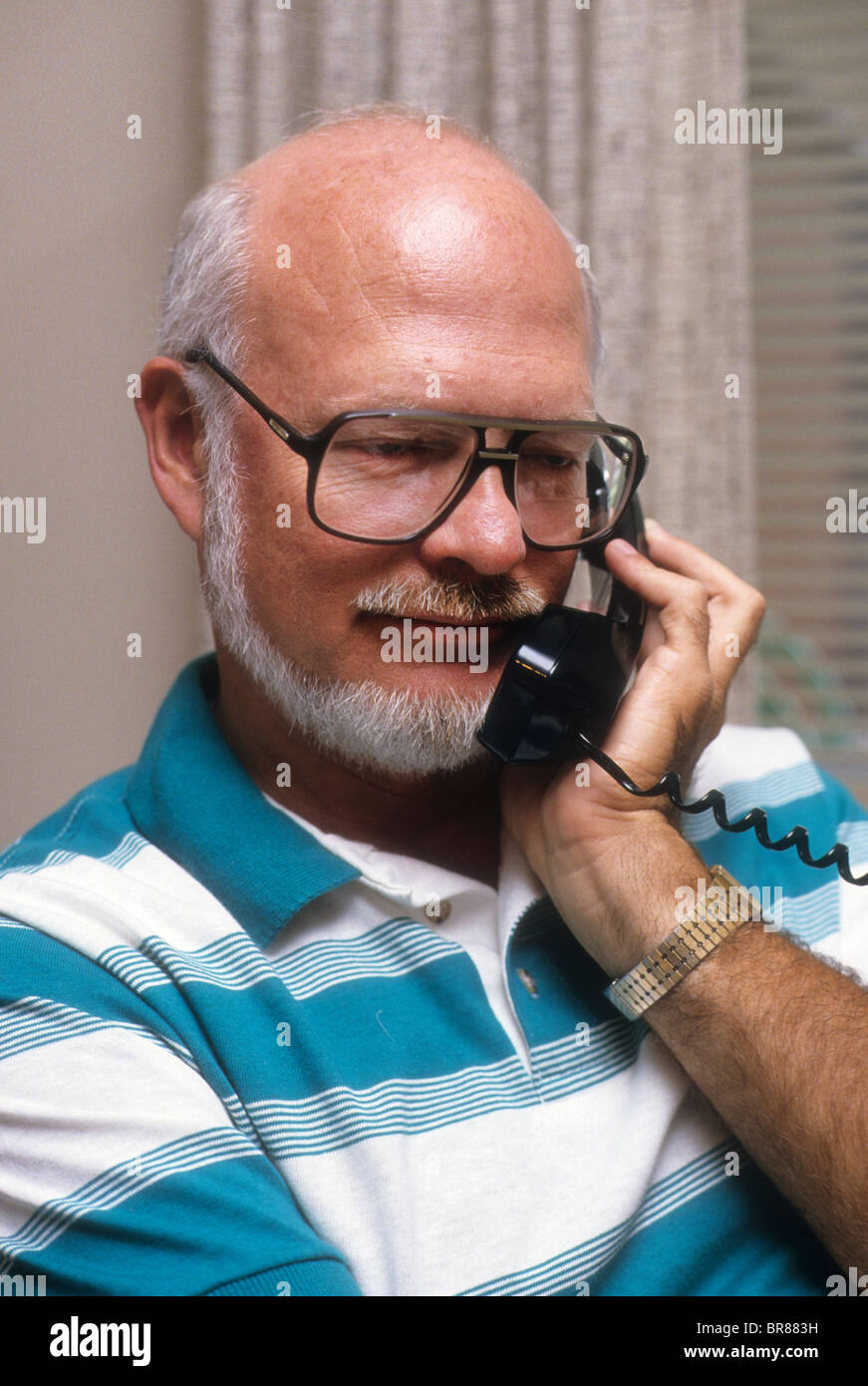 senior bald man male talk phone listen attention smile happy news ...