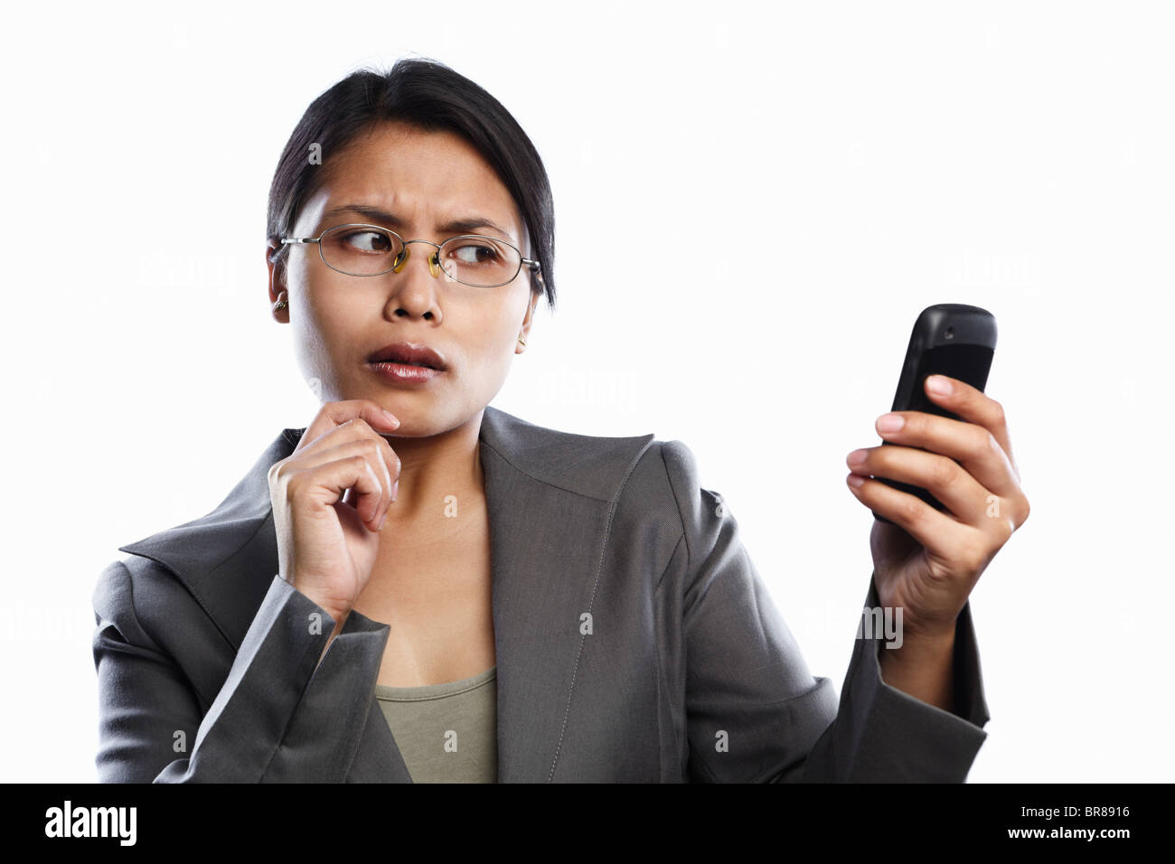 Asian businesswoman curious expression using video call of her cell ...