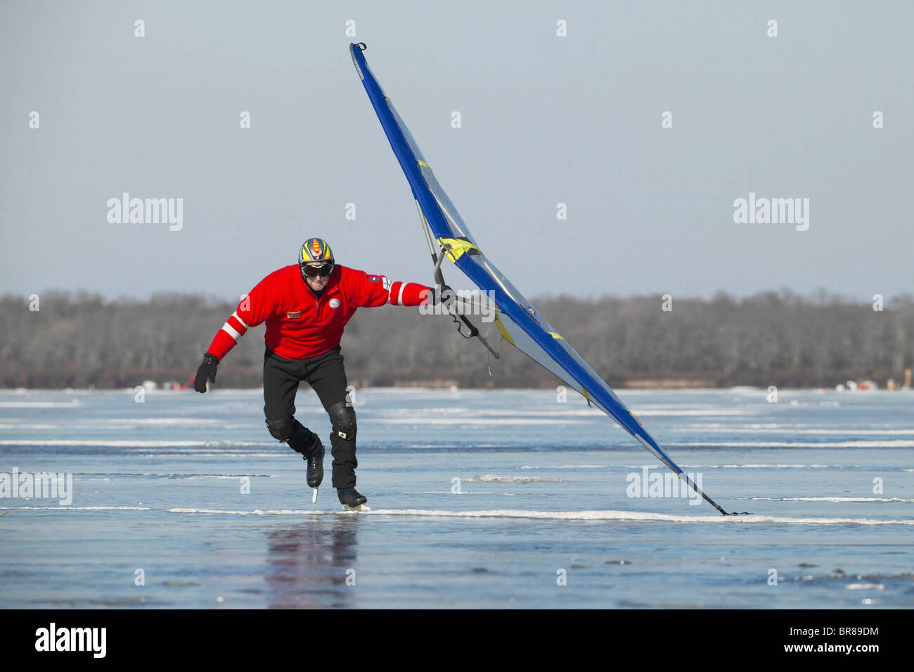 Man ice skating with a sail on Worden Pond, Rhode Island, USA Stock ...