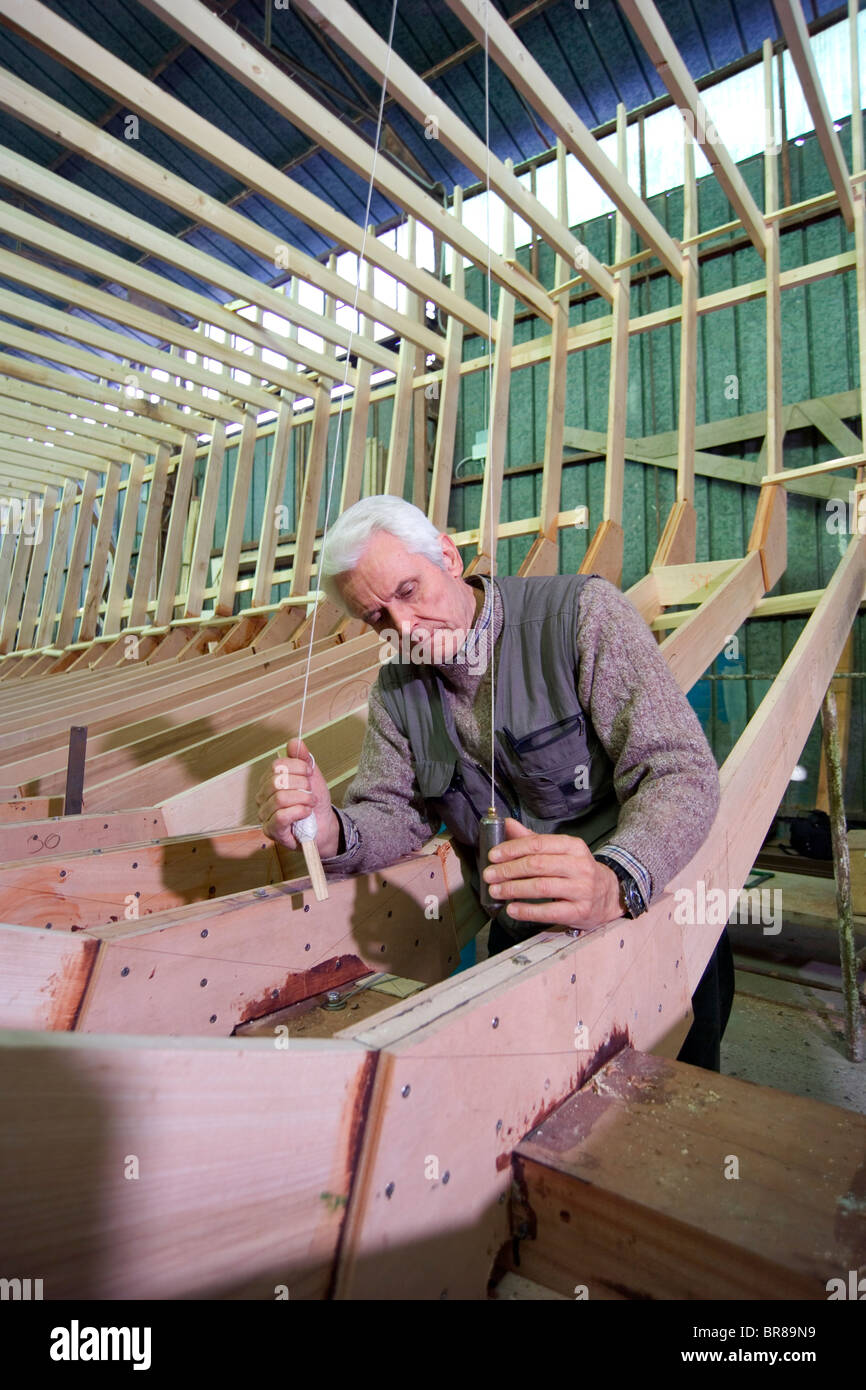 Shipwright at work with a plumb line during construction of a 38-metre ...