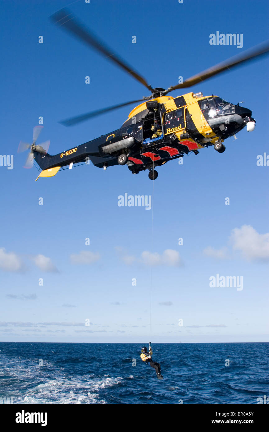 Winchman being lowered from a helicopter during a training excercise on ...