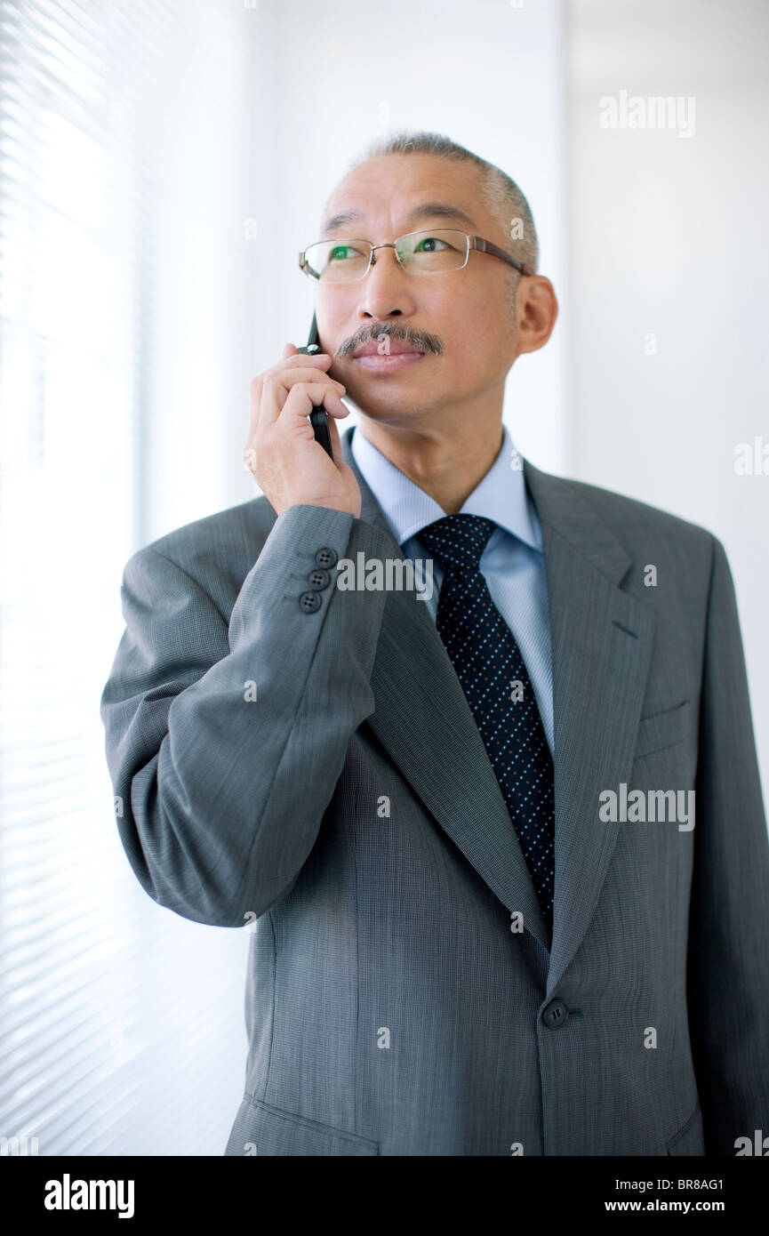 Businessman using mobile phone Stock Photo - Alamy