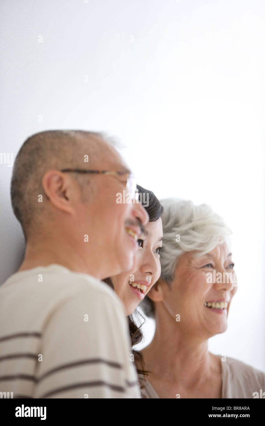 Family standing side by side, smiling, white background Stock Photo - Alamy