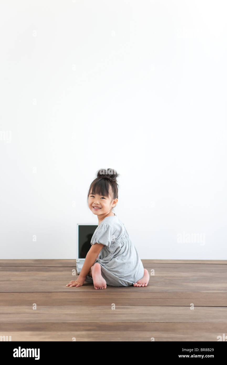 Portrait of girl using laptop, looking back, white background, copy ...