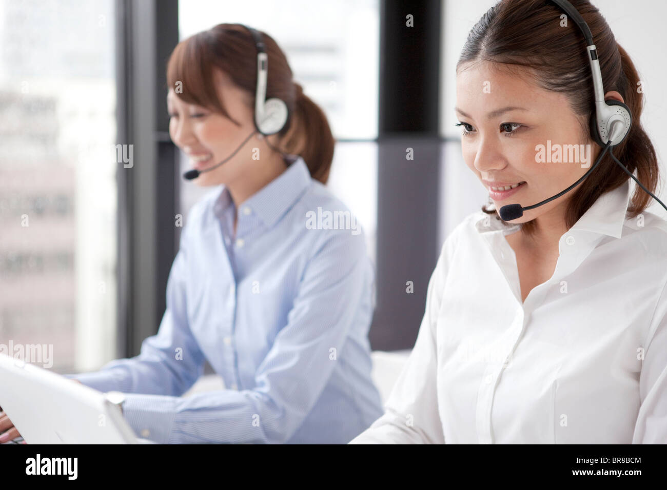 Customer Service Representatives with headset Stock Photo - Alamy