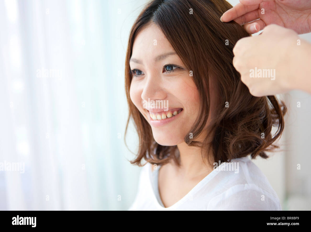 Woman having her hair done Stock Photo - Alamy