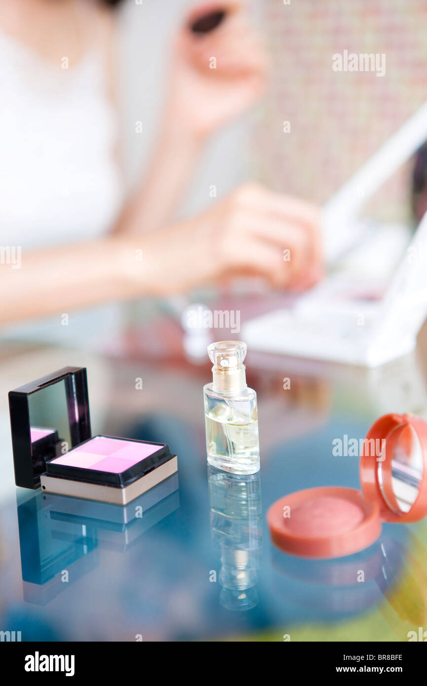 Woman applying makeup Stock Photo - Alamy