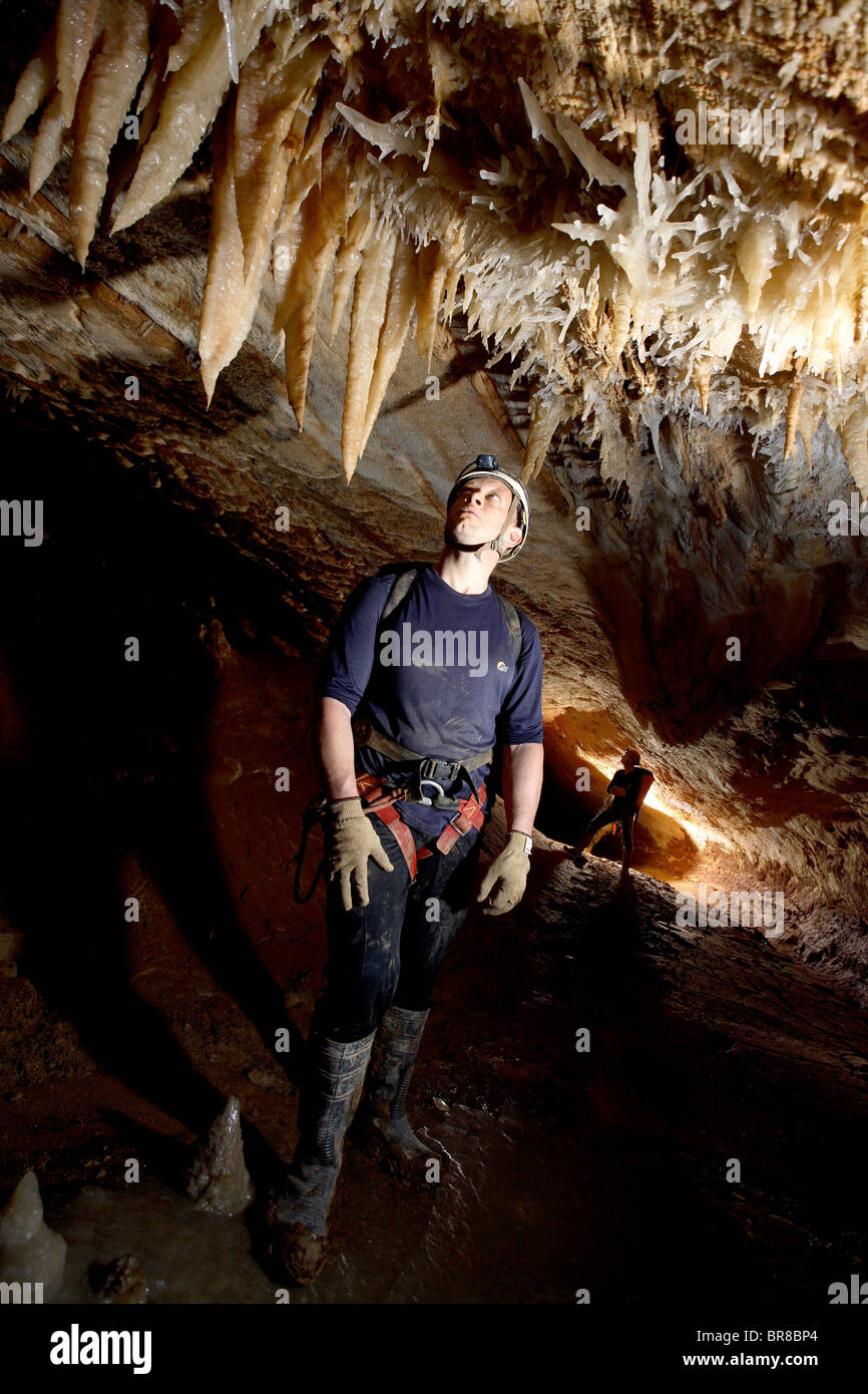 Fascinated by the pretty formations this cave explorer poses for scale ...