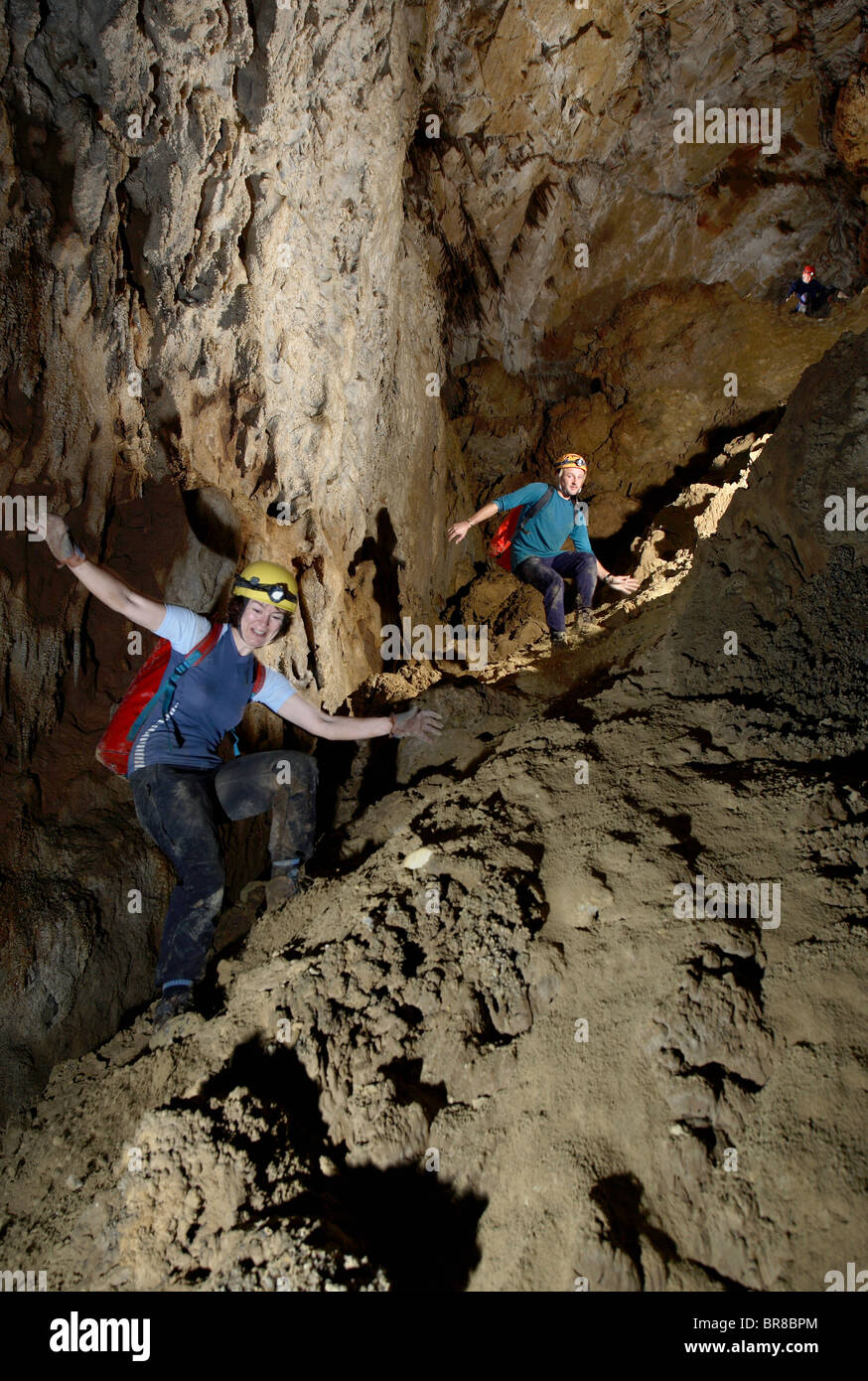 Three cave explorers tackle a steep rubble slope on their way to an ...