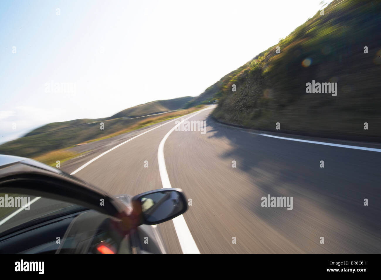A Car Running on Winding Road in Mountain Stock Photo - Alamy