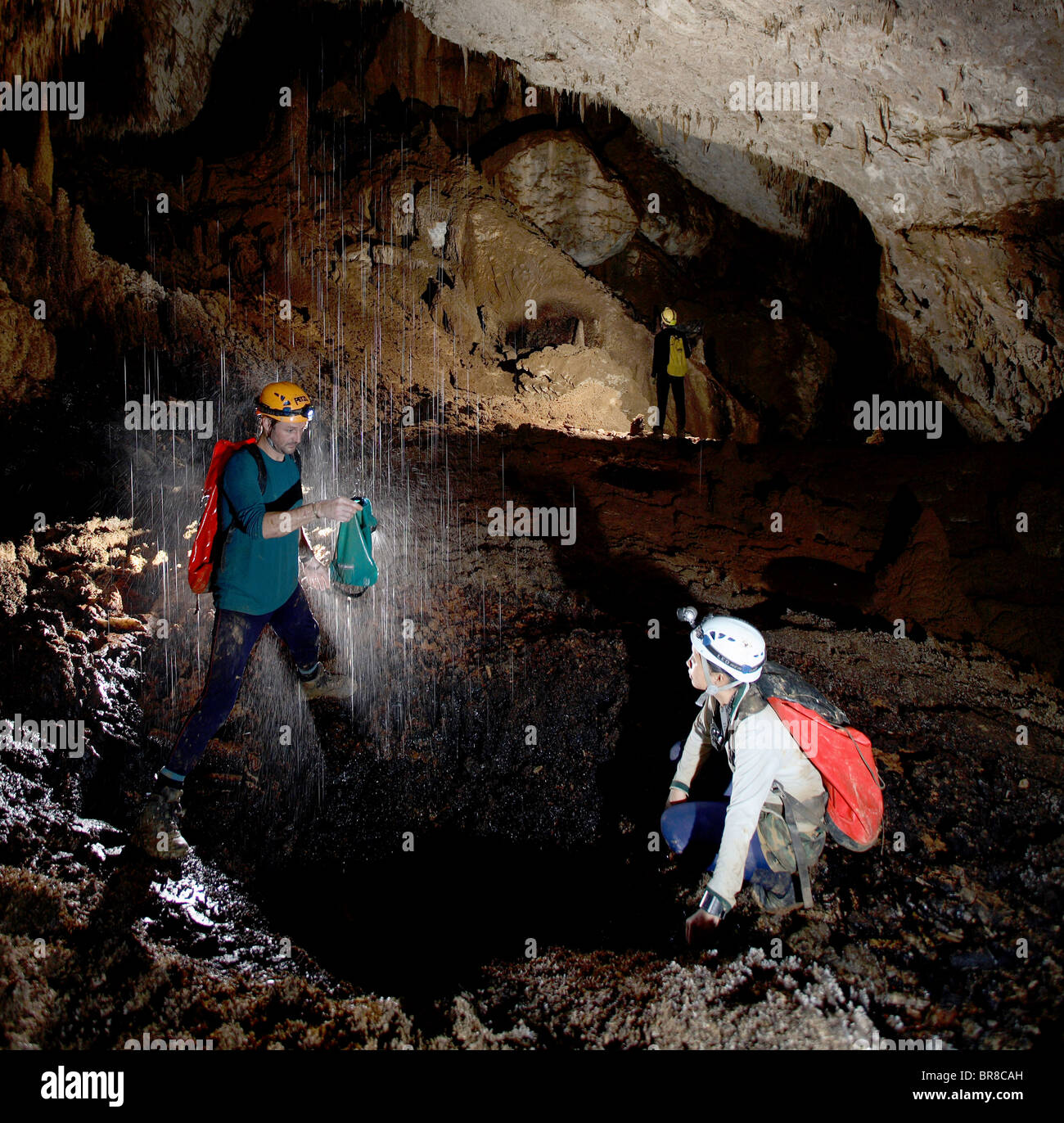 Two cave explorers collect water from an inlet inside Whiterock (cave ...
