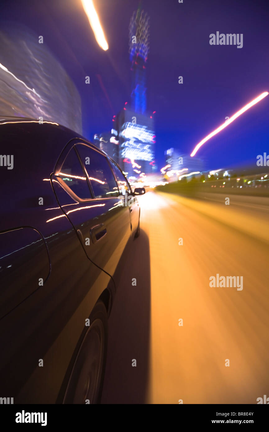 Car driving on road at night Stock Photo - Alamy