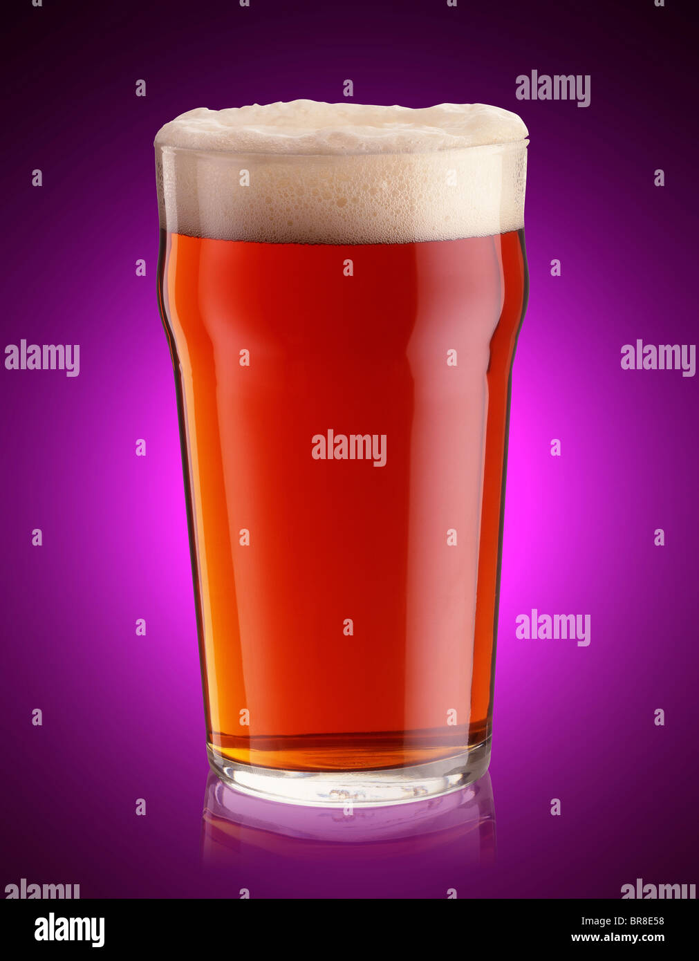 pint of bitter against a pink background Stock Photo - Alamy